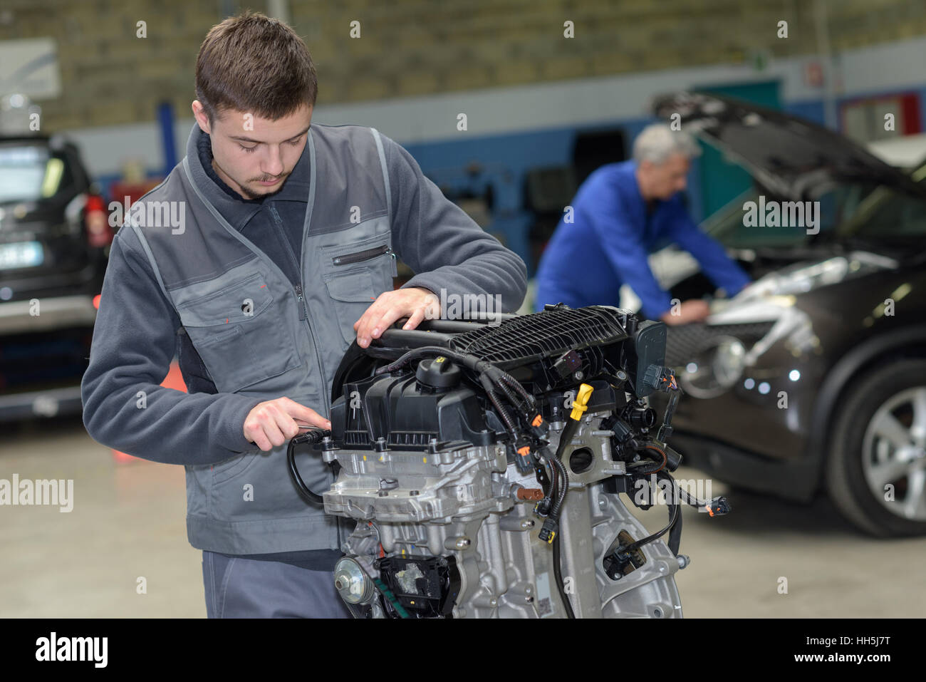 apprentice mechanic in auto shop working on car engine Stock Photo - Alamy