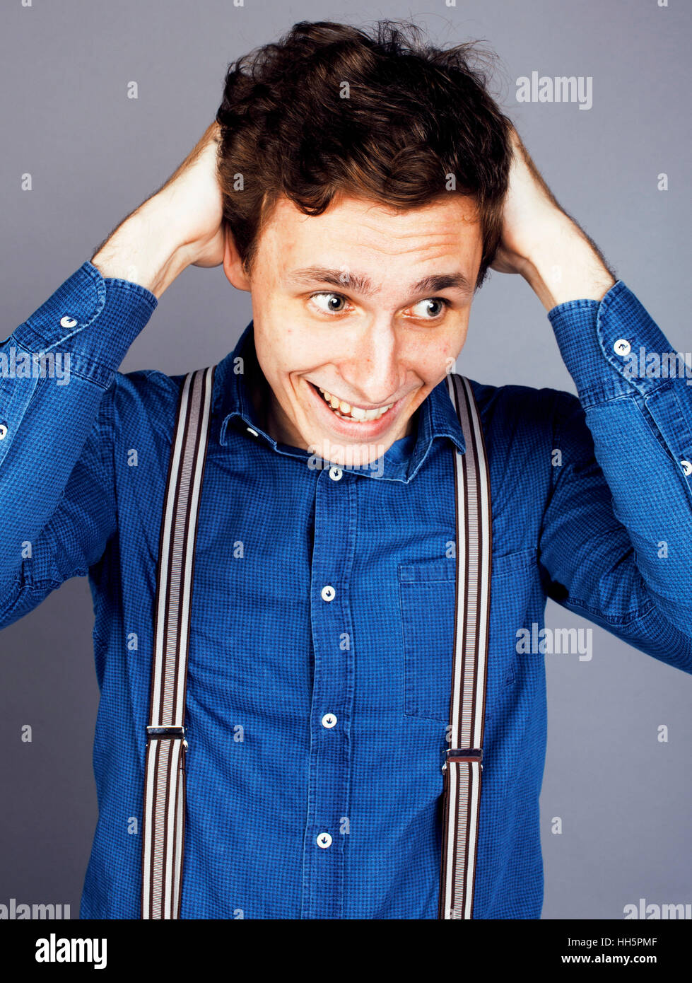 young goofy man with pimples pointing in studio Stock Photo - Alamy