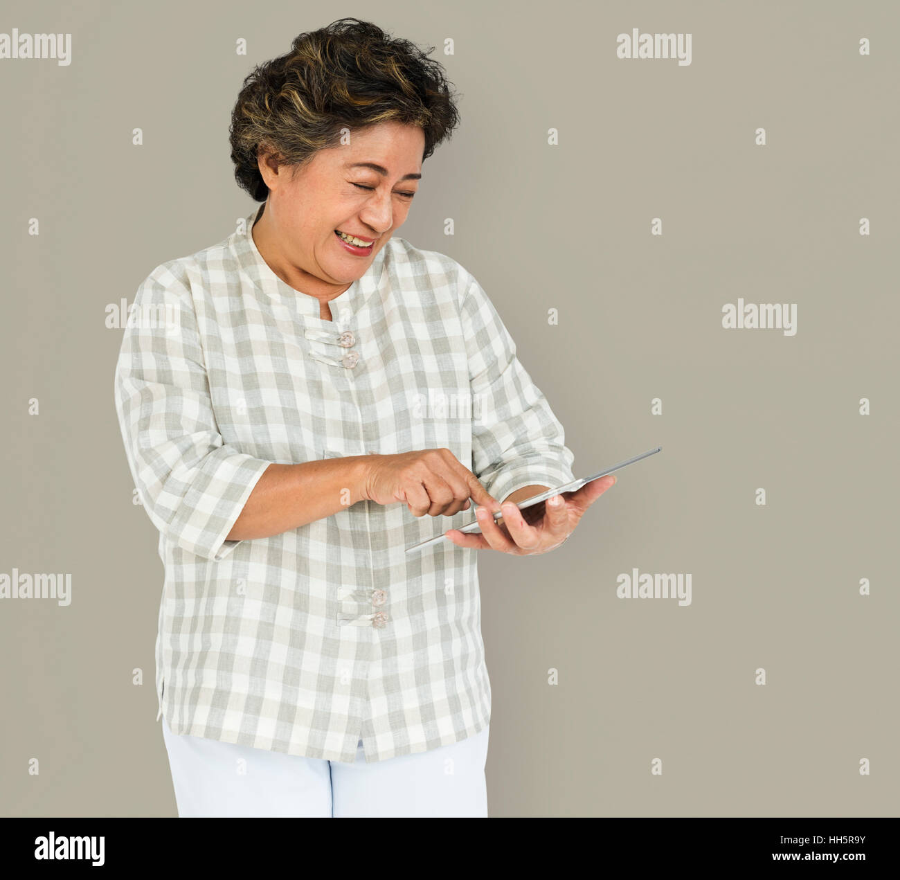 Mature Woman Holding Tablet Concept Stock Photo - Alamy