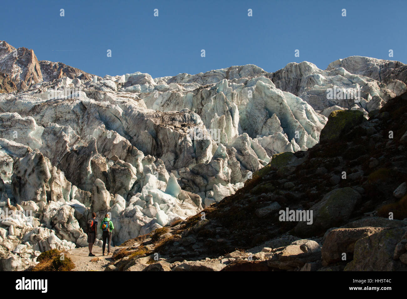 Two adults looking glacier, chamonix, france Stock Photo - Alamy