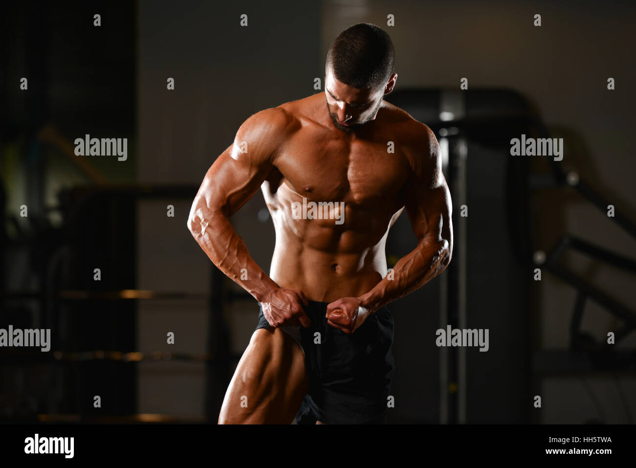 Healthy Man Standing Strong In The Gym And Flexing Muscles - Muscular ...