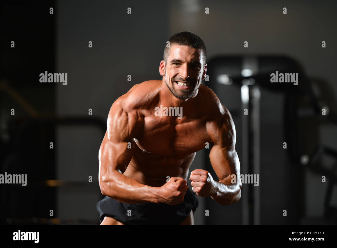 Healthy Man Standing Strong In The Gym And Flexing Muscles - Muscular ...