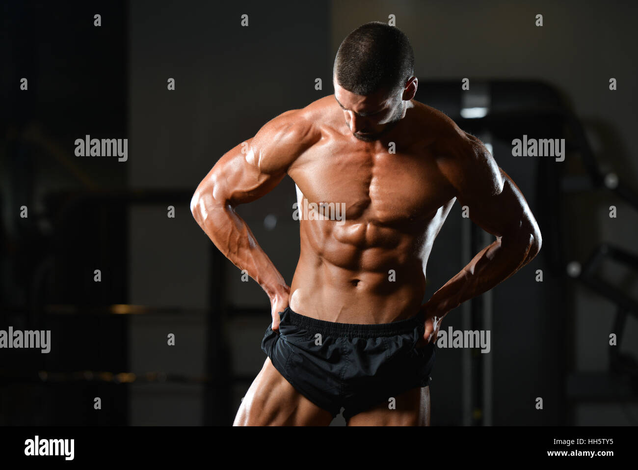 Healthy Man Standing Strong In The Gym And Flexing Muscles - Muscular ...
