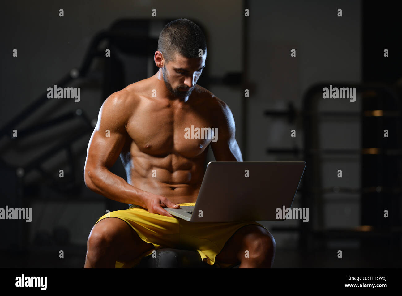 Portrait Of A Young Physically Fit Man Using Laptop - Muscular Athletic ...