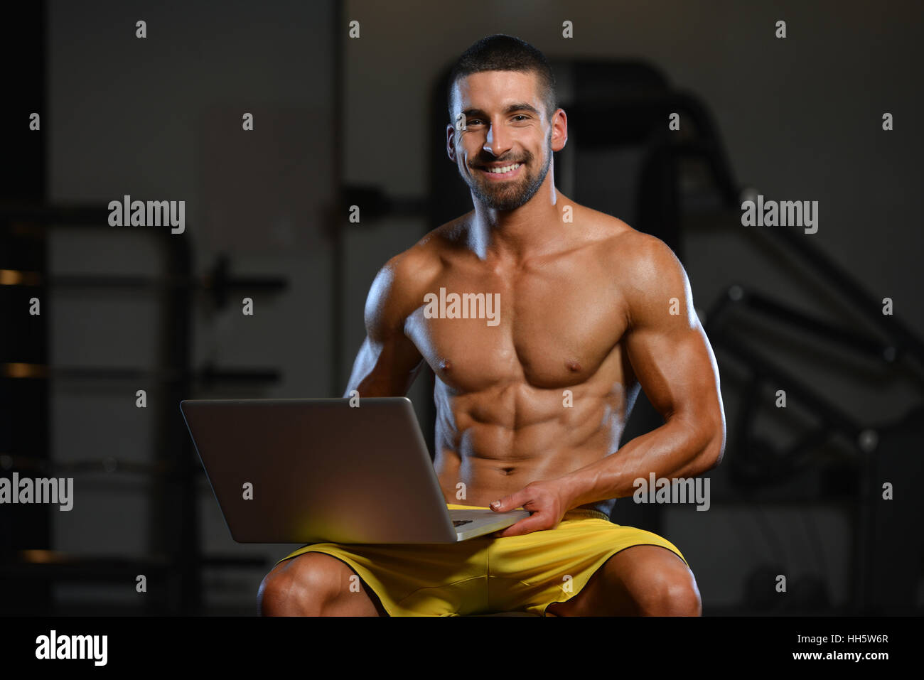 Portrait Of A Young Physically Fit Man Using Laptop - Muscular Athletic ...