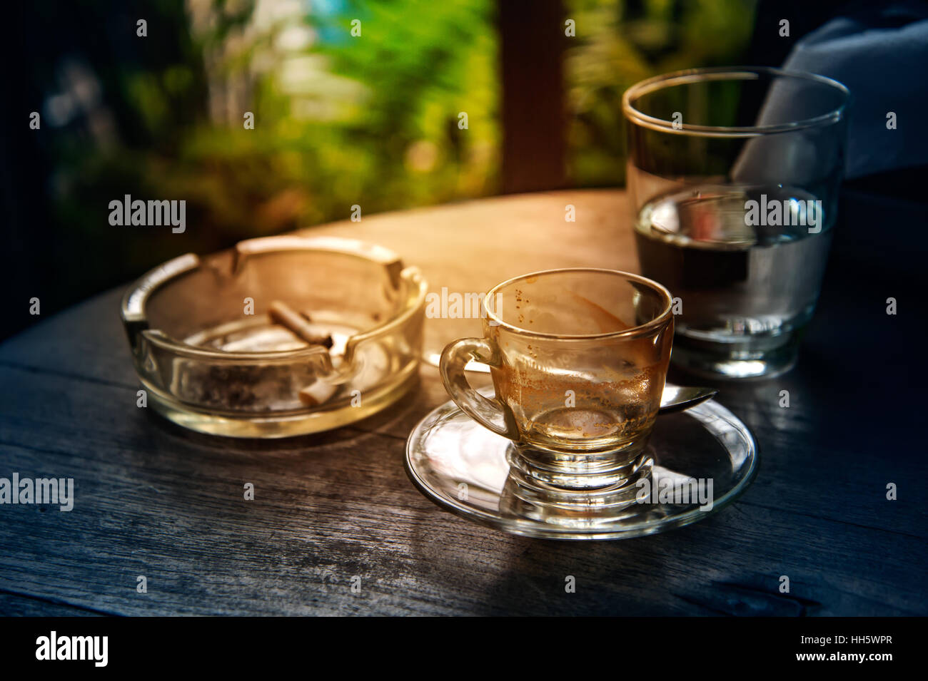 empty coffee cup and ashtray on table Stock Photo - Alamy