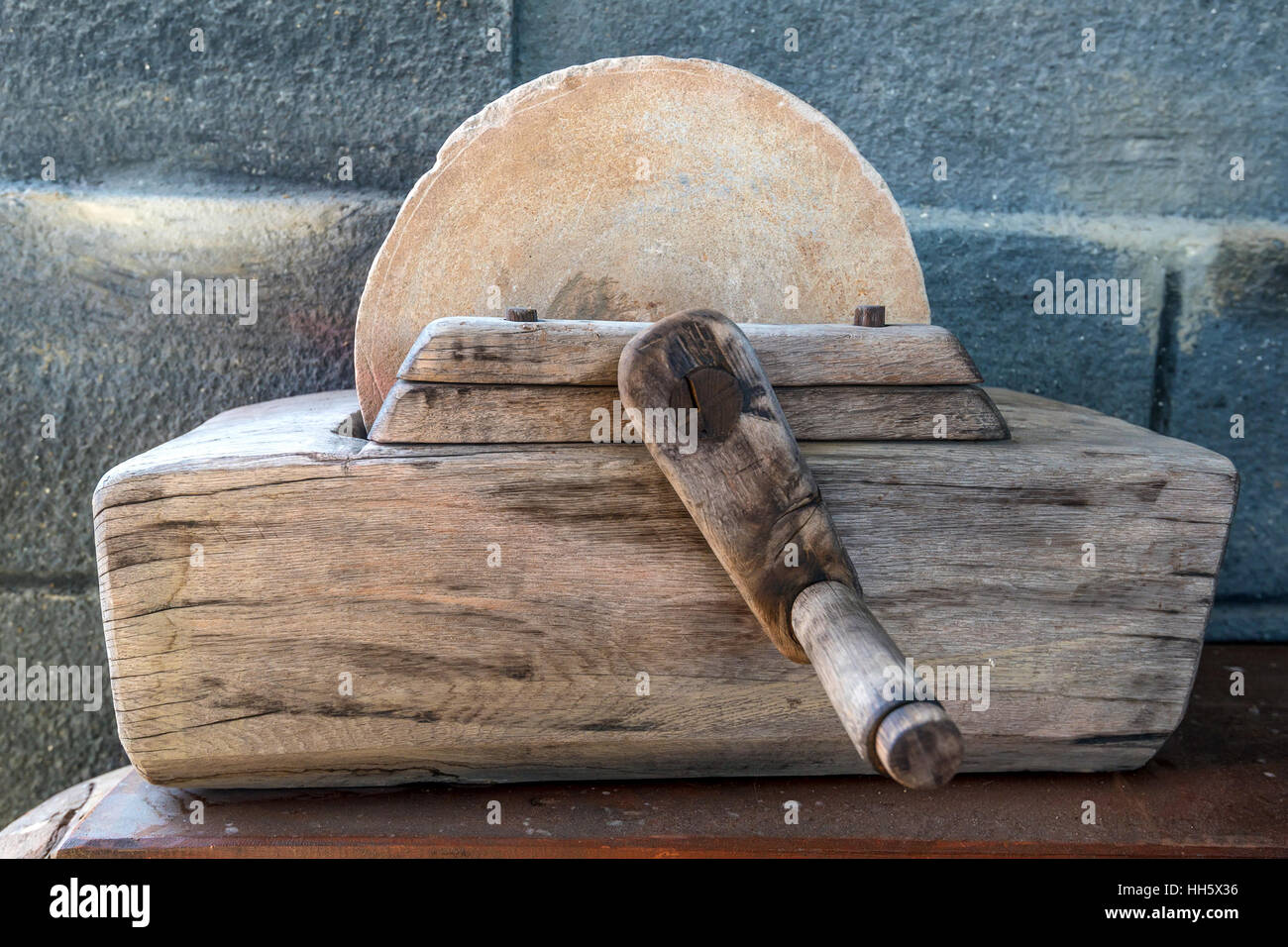 Close-up of old primitive grinding stone with wooden mechanism Stock ...
