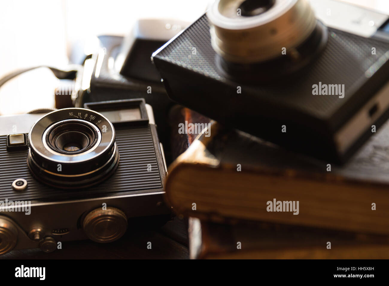 vintage camera close-up on wooden table on background of old books ...