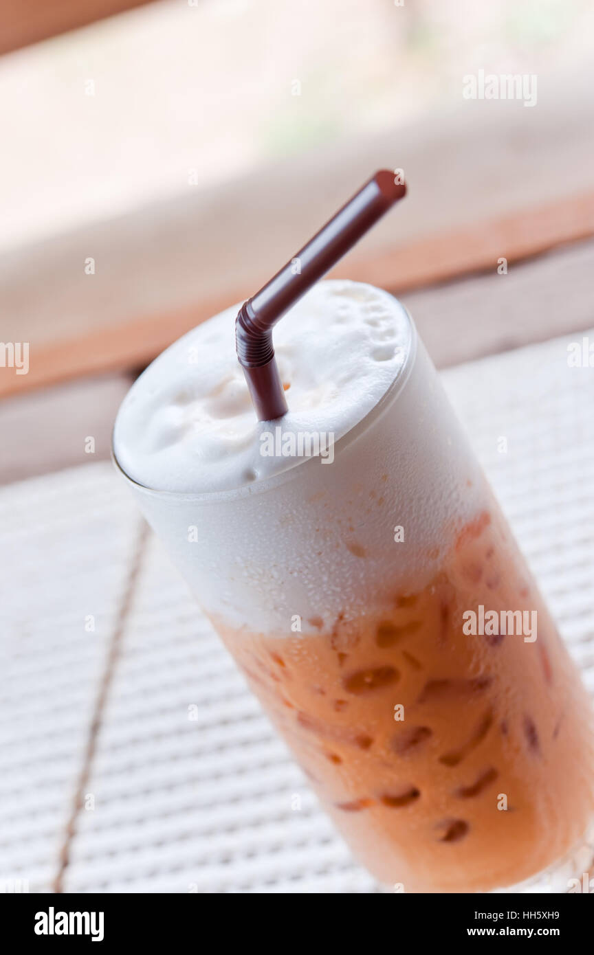 Iced thai milk tea with milk foam Stock Photo - Alamy