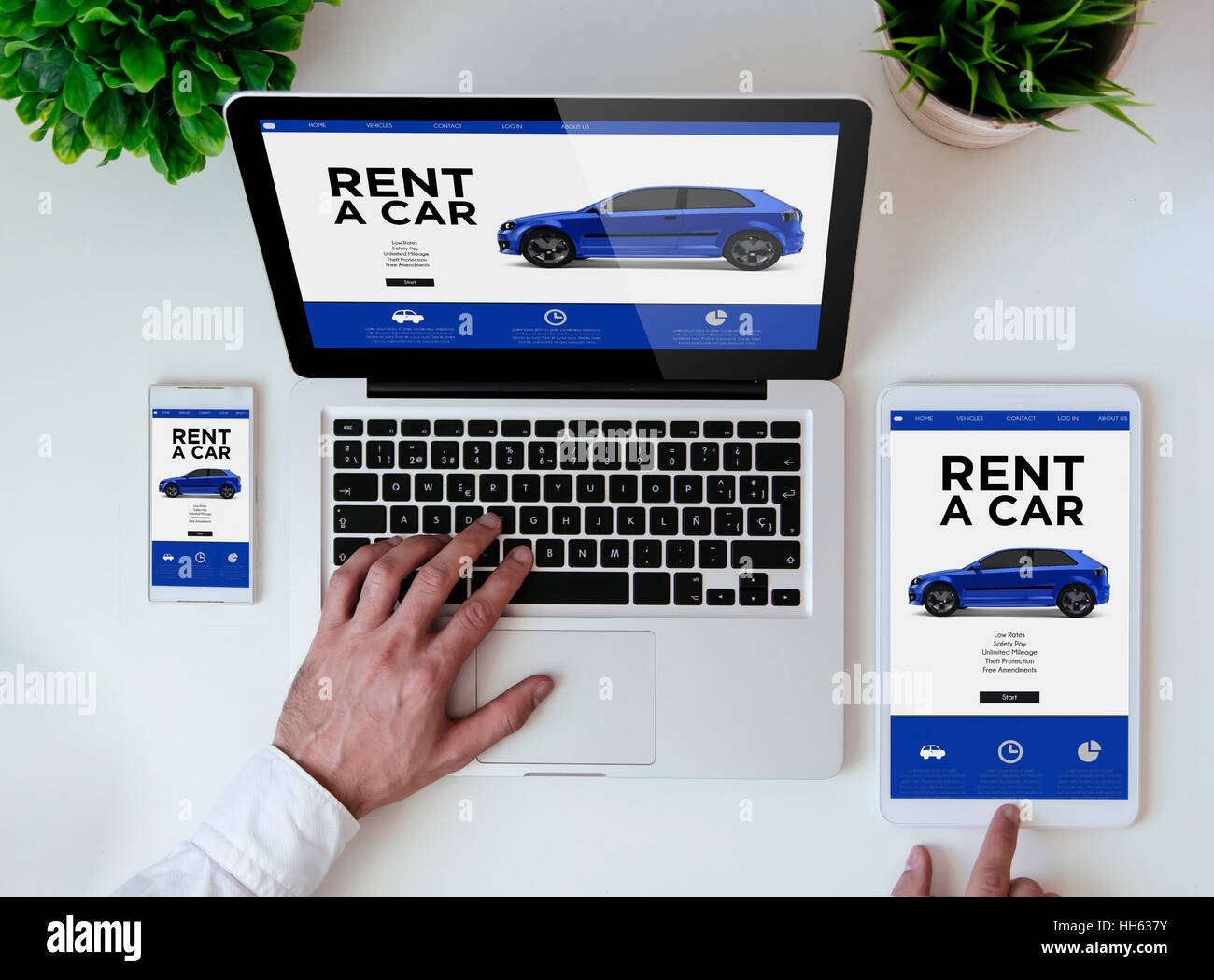 office tabletop with tablet, smartphone and laptop showing rent a car ...