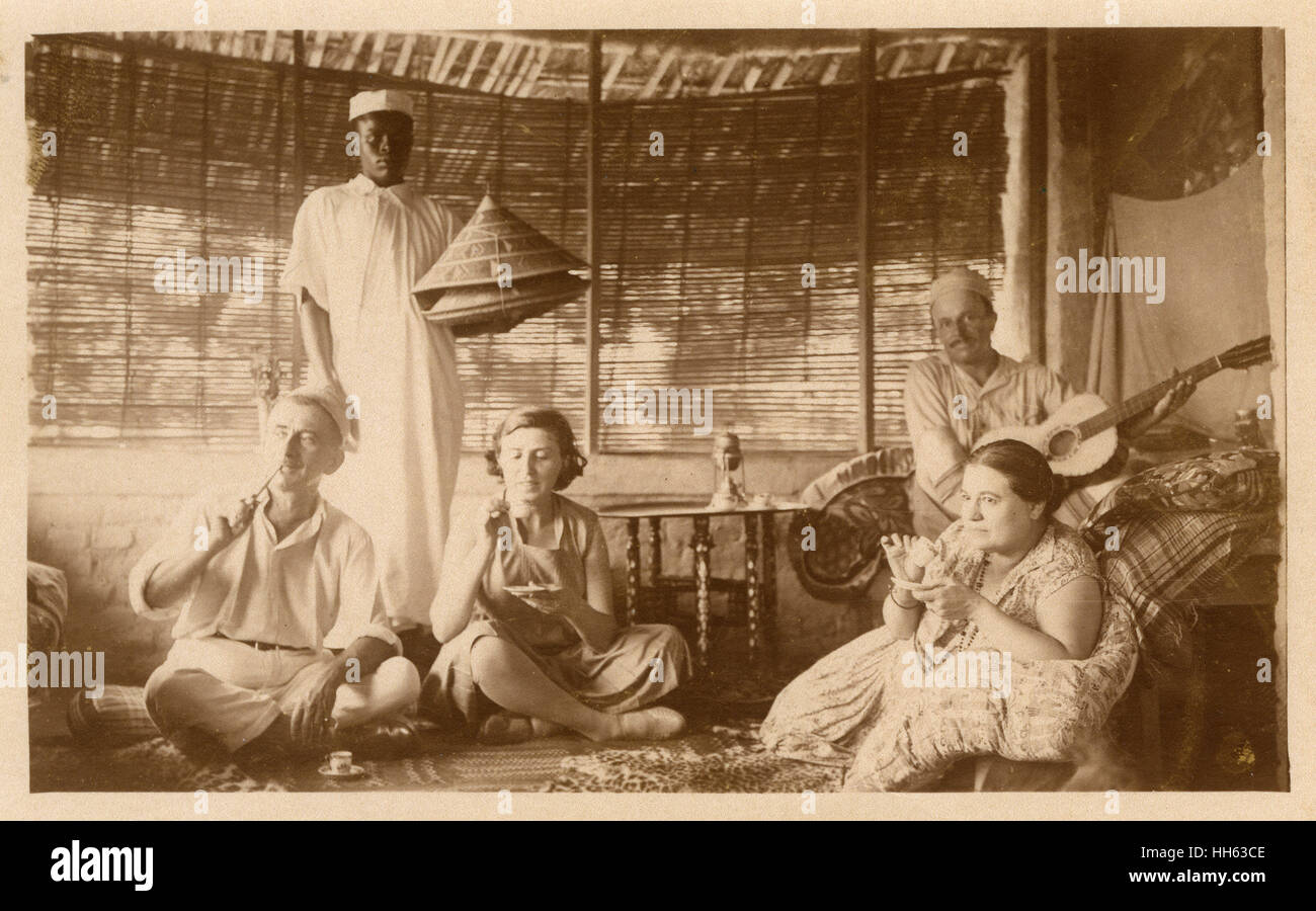 Colonial tea party with guitarist and servant Stock Photo - Alamy