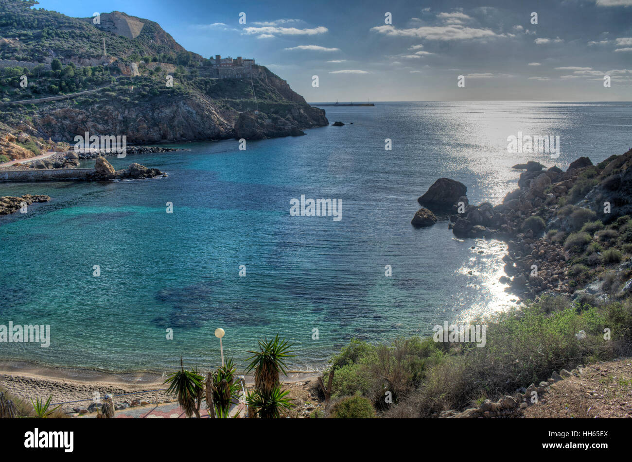 Sunshine shimmers on the Mediterranian Sea at Cala Cortina beach in ...
