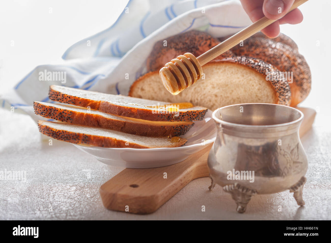 Braided Challah bread and honey on a white background Stock Photo - Alamy