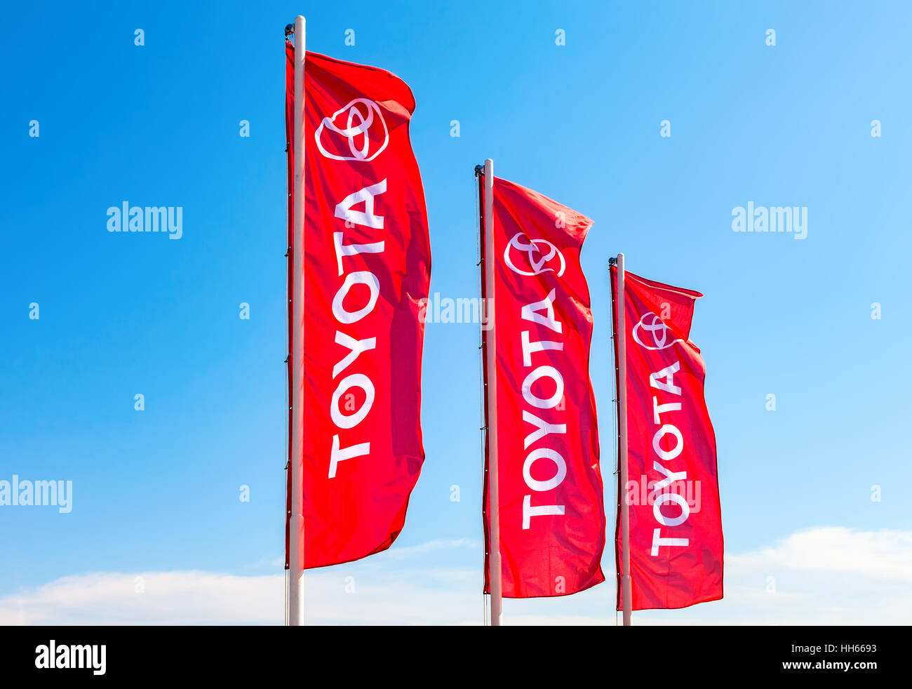 Official dealership flags of Toyota against the blue sky. Toyota Motor ...