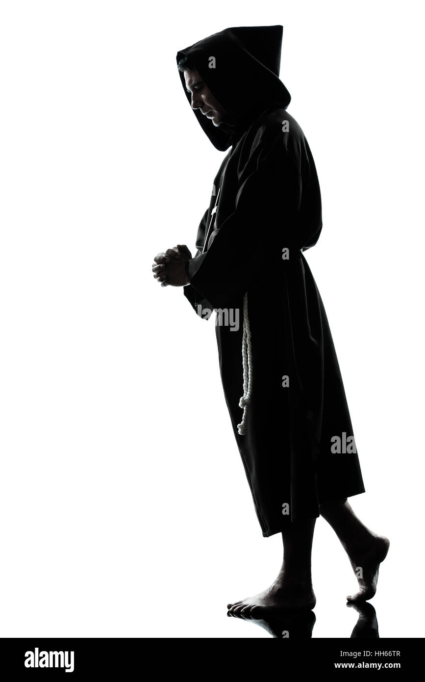 one caucasian man priest praying silhouette in studio isolated on white ...