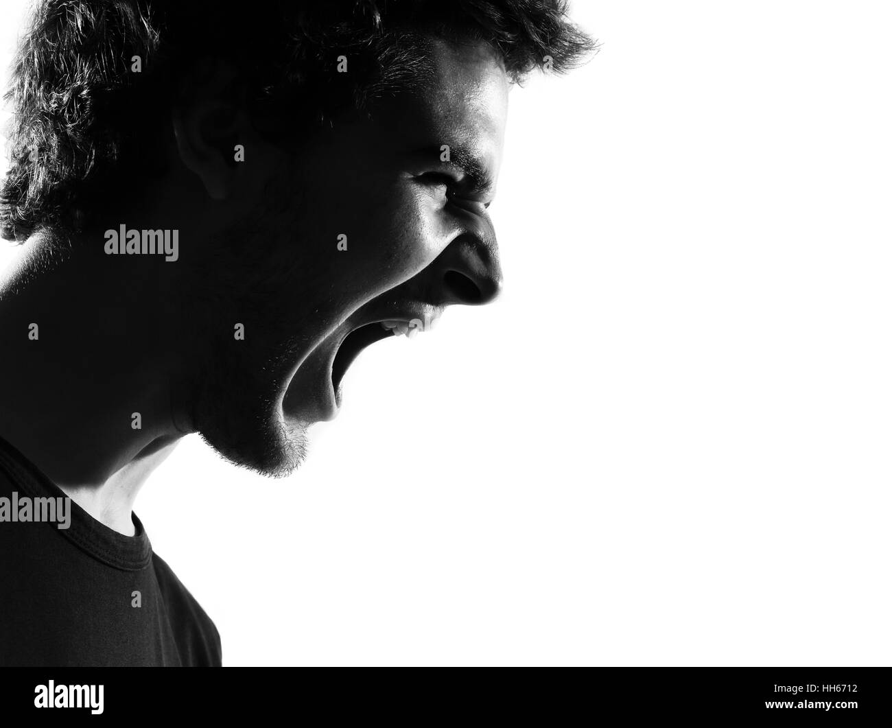 young man screaming angry portrait silhouette in studio isolated on ...