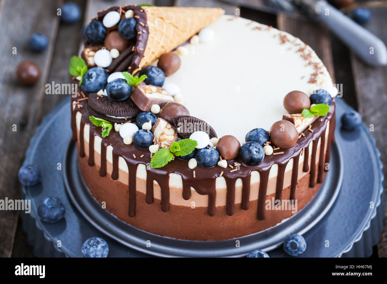 Delicious three chocolate mousse cake decorated with waffle cone, fresh ...