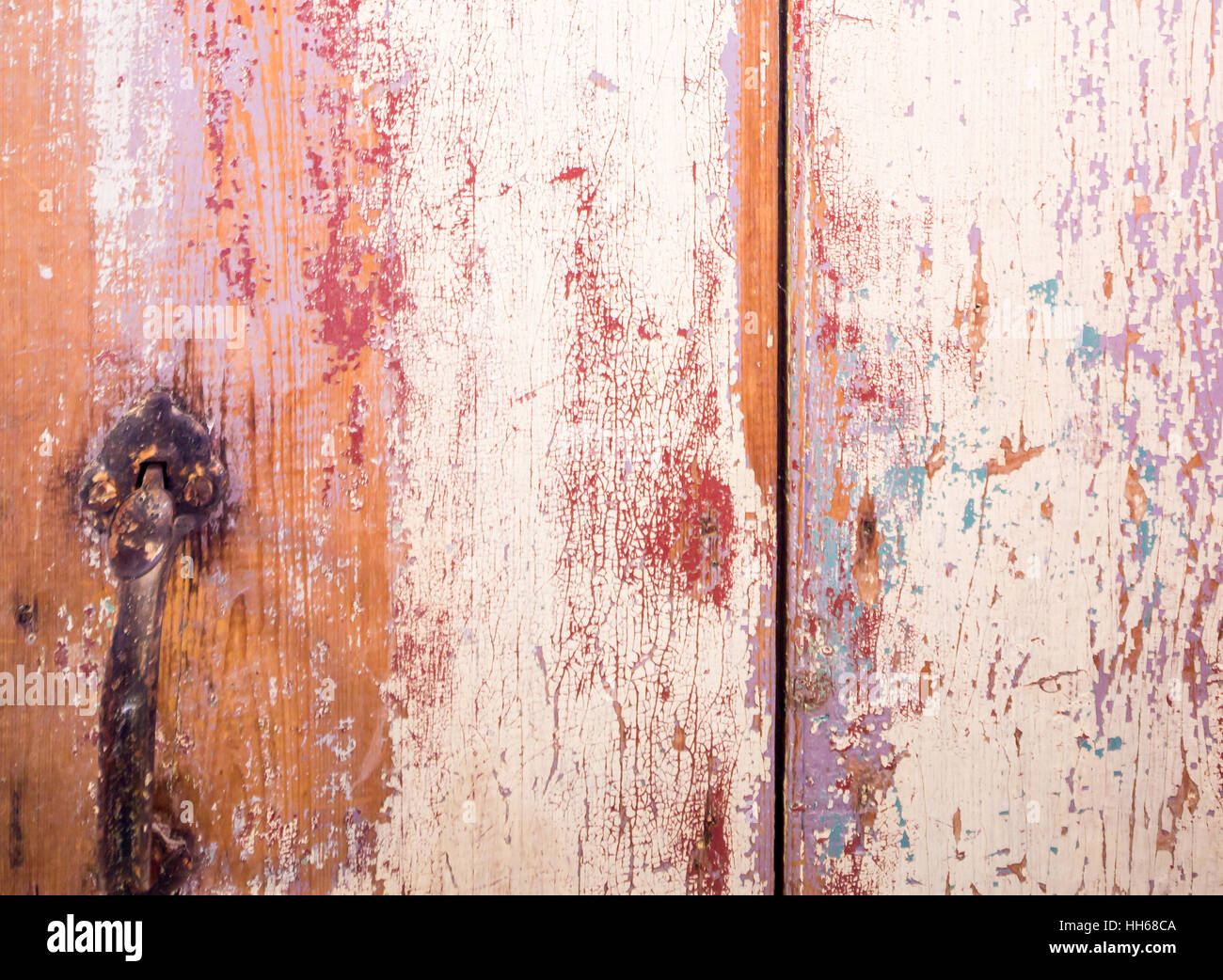 detail of an old wooden door with layers upon layers of paint that has ...