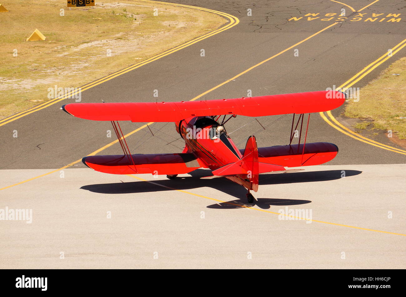 red biplane taxiing Stock Photo - Alamy