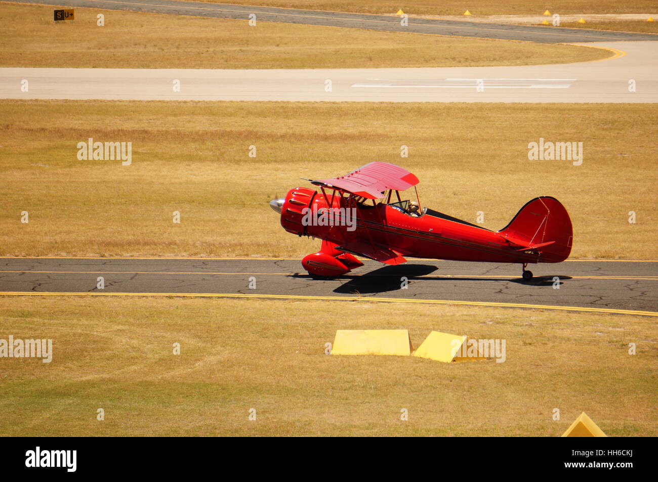 red biplane taxiing Stock Photo - Alamy
