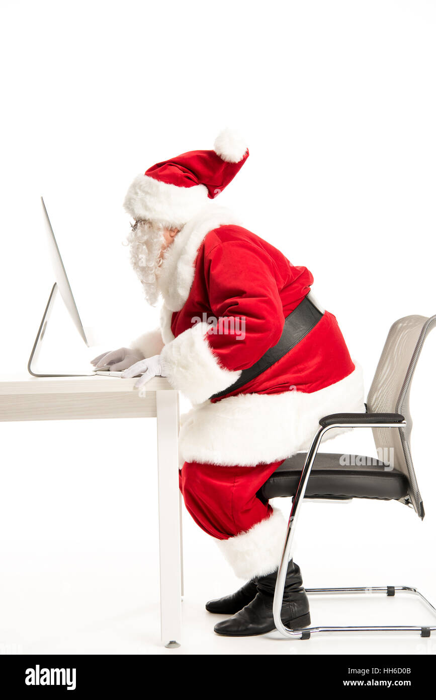 Side view of Santa Claus using computer isolated on white Stock Photo ...
