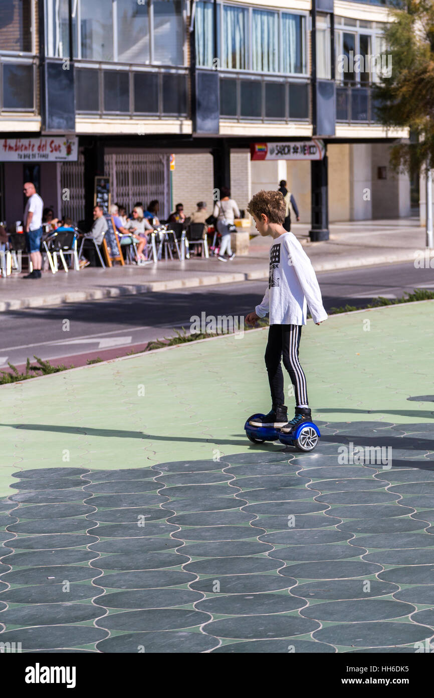 Young boy riding hoverboard on Benidorm Poniente beach promenade Stock ...