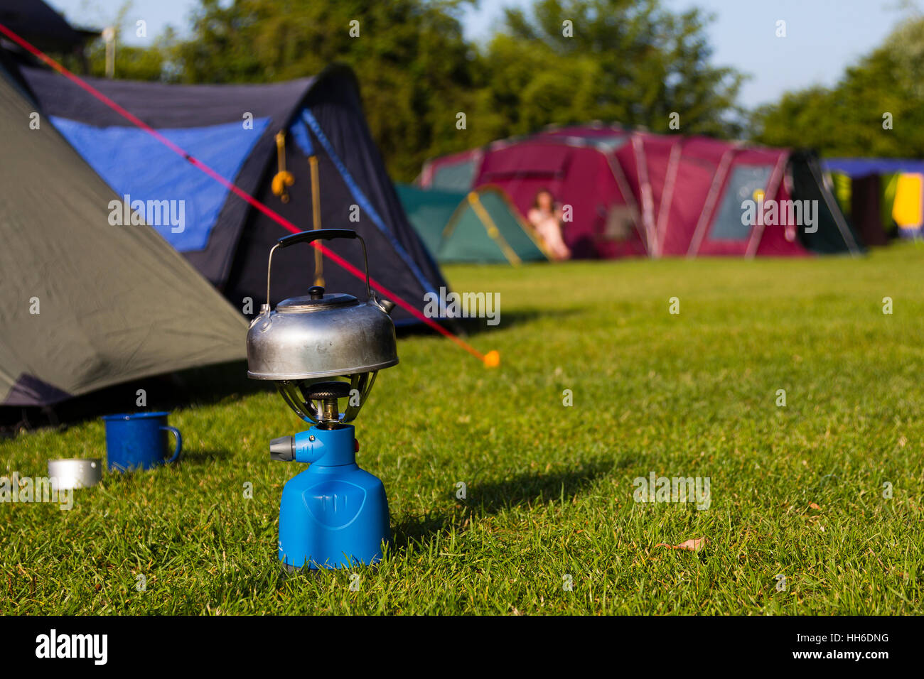 View of small camp stove with kettle on it on busy campground Stock ...