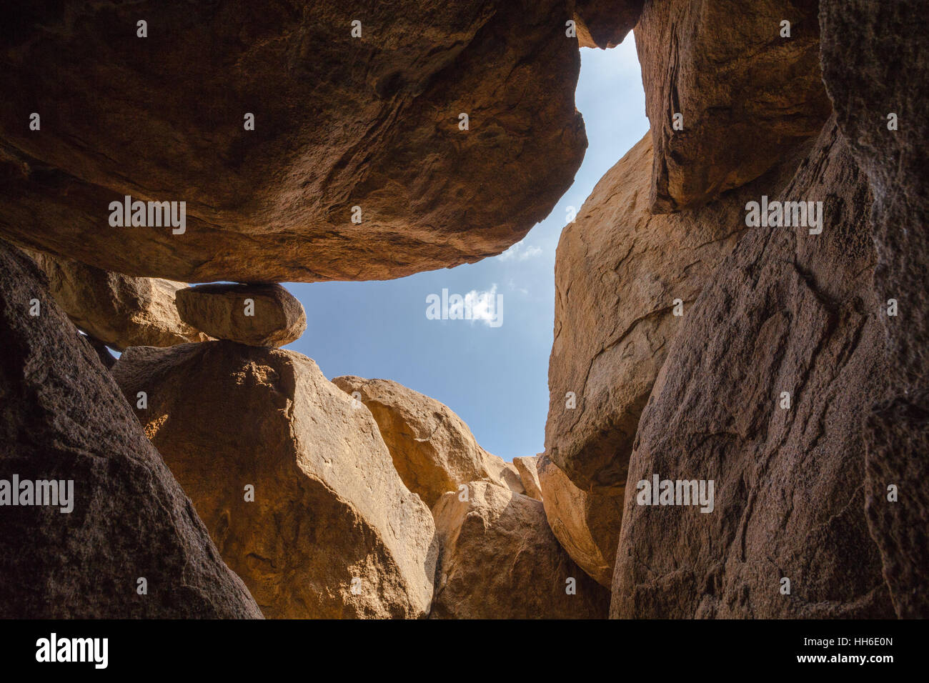 Abstract formation of boulders against blue sky, on a bright sunny day ...