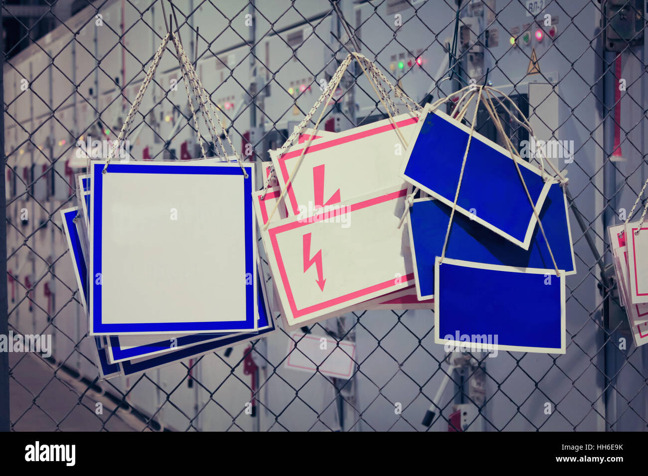 Warning labels on the background of control cabinets Stock Photo - Alamy