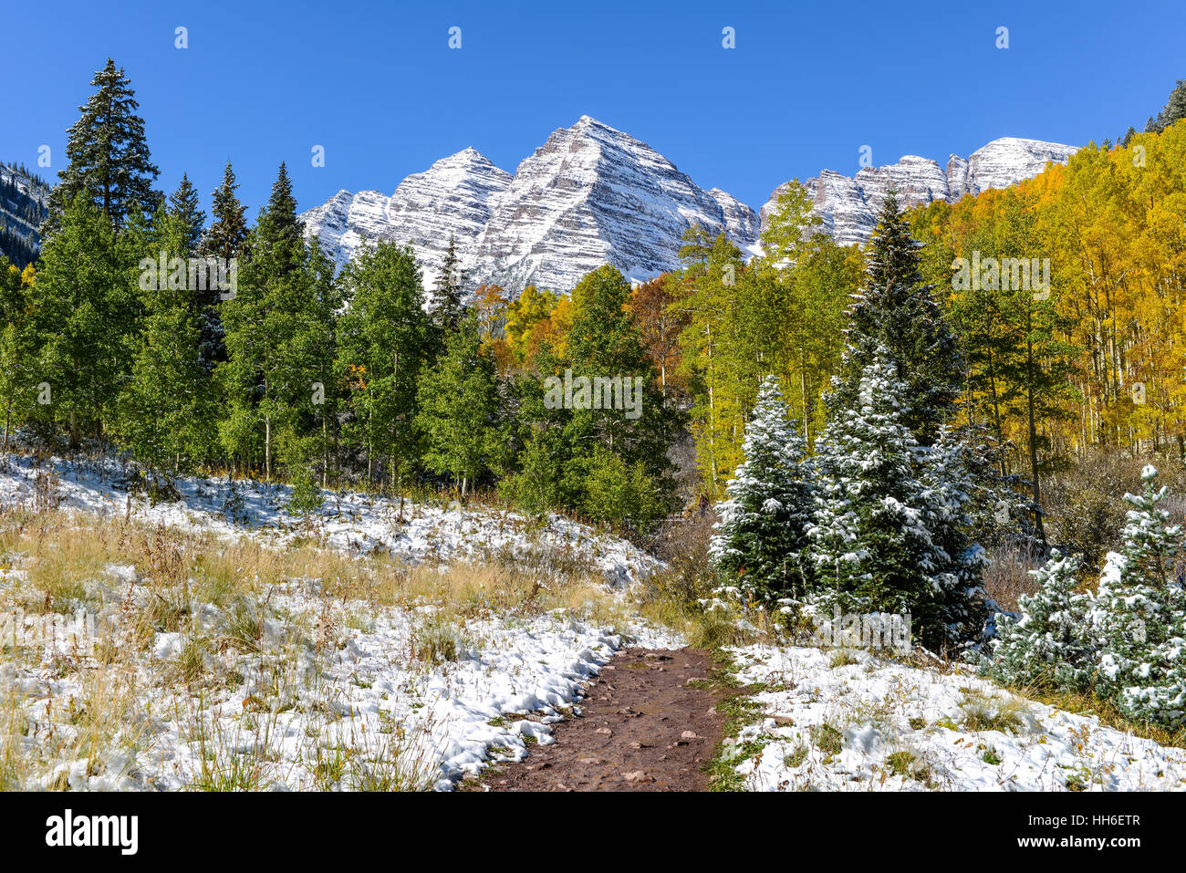 Autumn Snow at Maroon Bells - A hiking trail extending toward snow ...