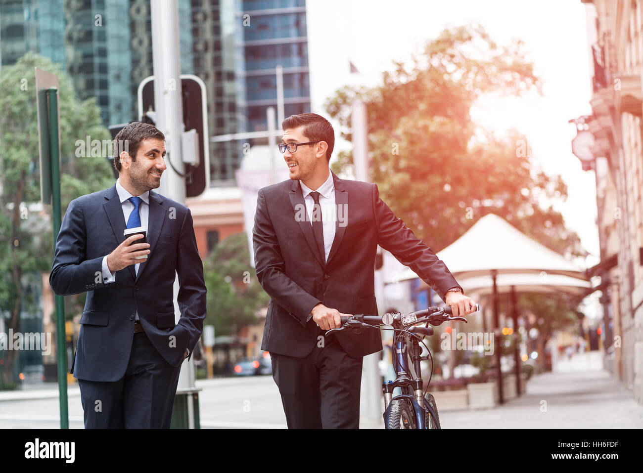 Two businessmen having walk Stock Photo - Alamy