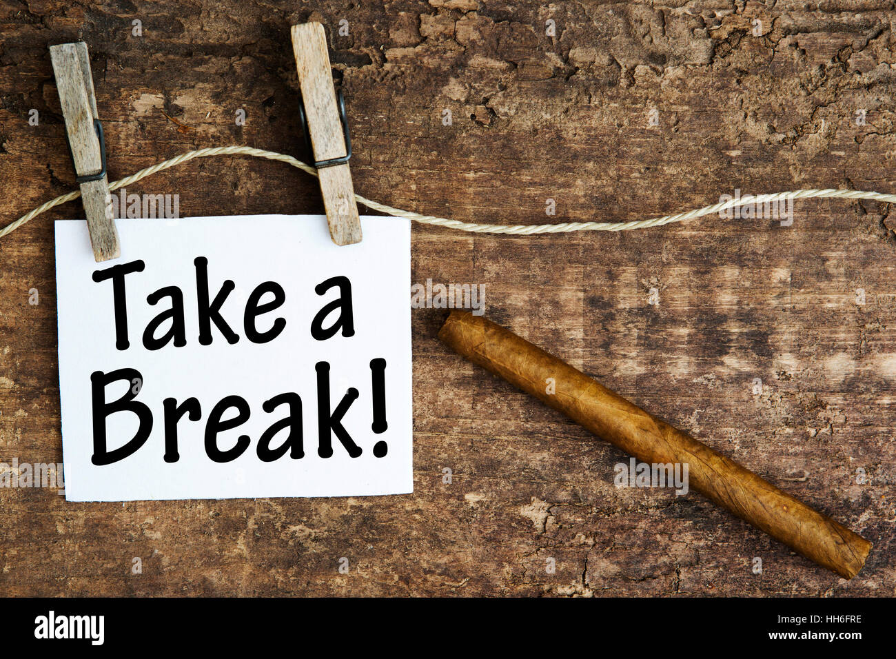 white paper sign with the words Take A Break hanging on clothesline ...