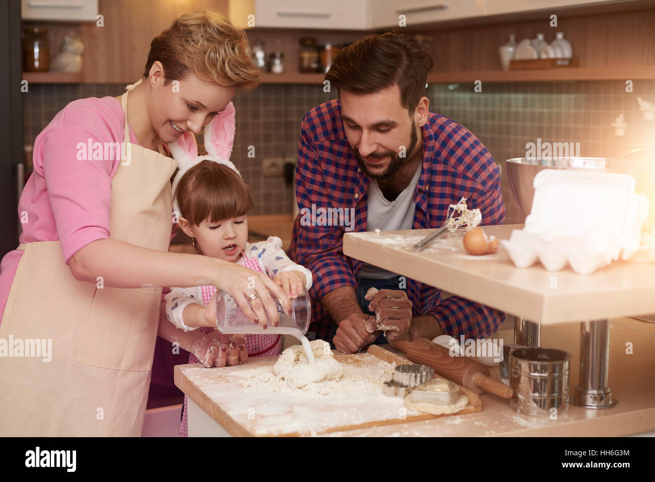 Little girl making her first cookie with parents Stock Photo - Alamy