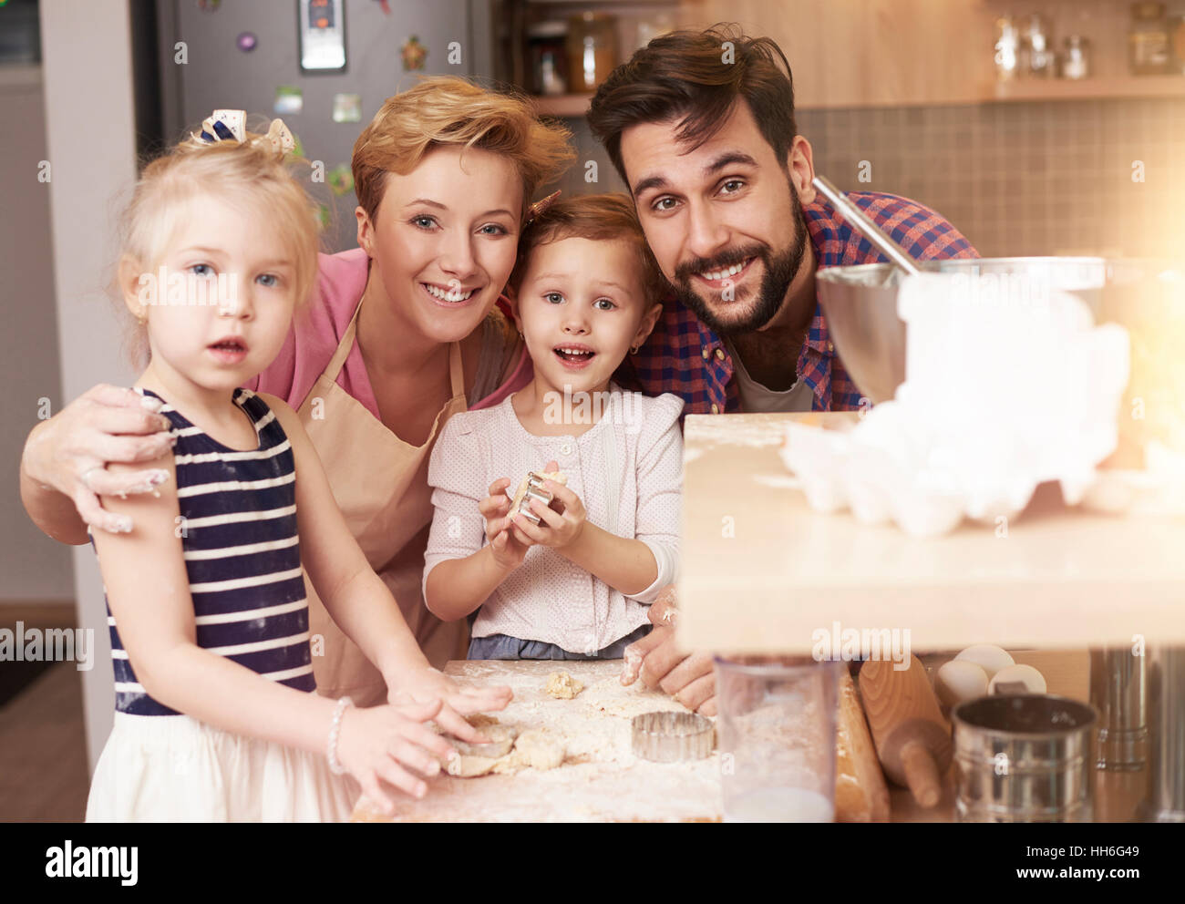 Portrait of four people family in the kitchen Stock Photo - Alamy