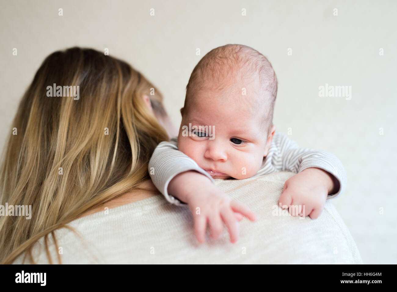 Unrecognizable young mother holding baby son in her arms Stock Photo - Alamy