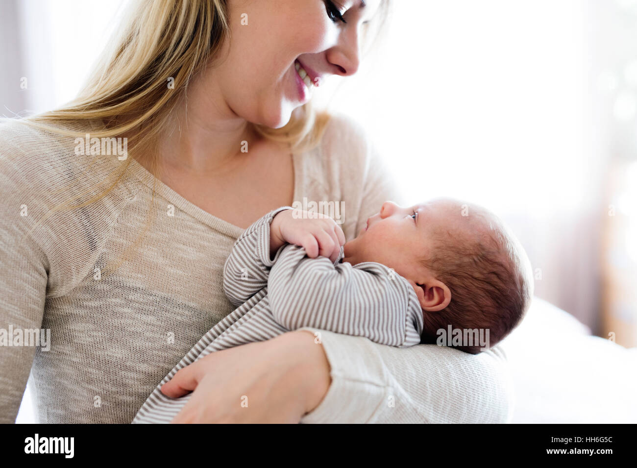 Beautiful young mother holding baby son in her arms Stock Photo - Alamy Beautiful young mother holding baby son in her arms Stock Photo - Alamy