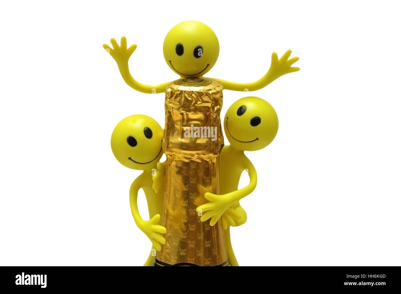 Three smilies ovet the bottle of champagne Stock Photo - Alamy