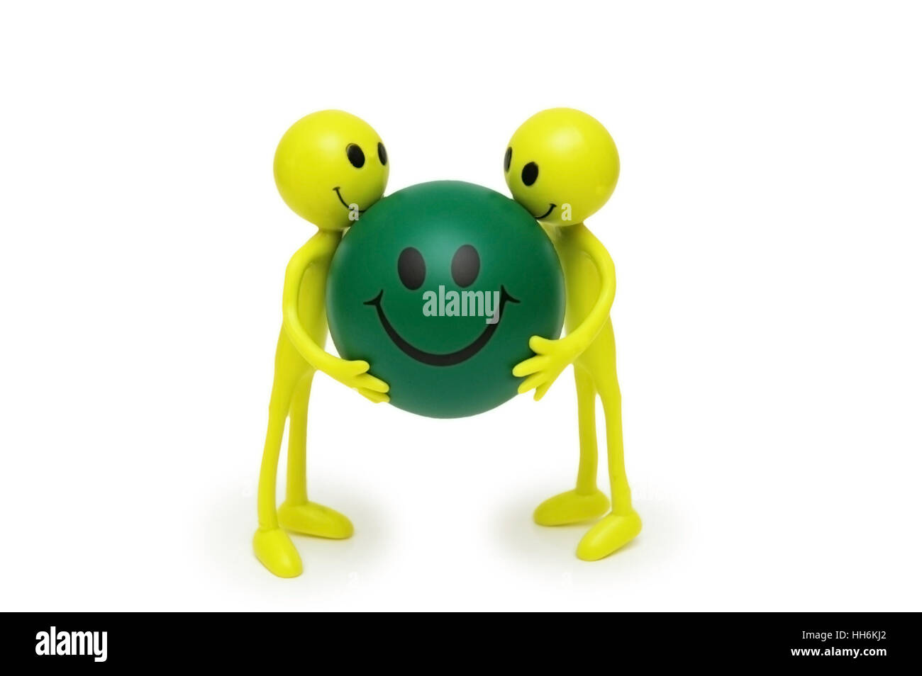 Two smilies holding ball with smile isolated on white Stock Photo - Alamy
