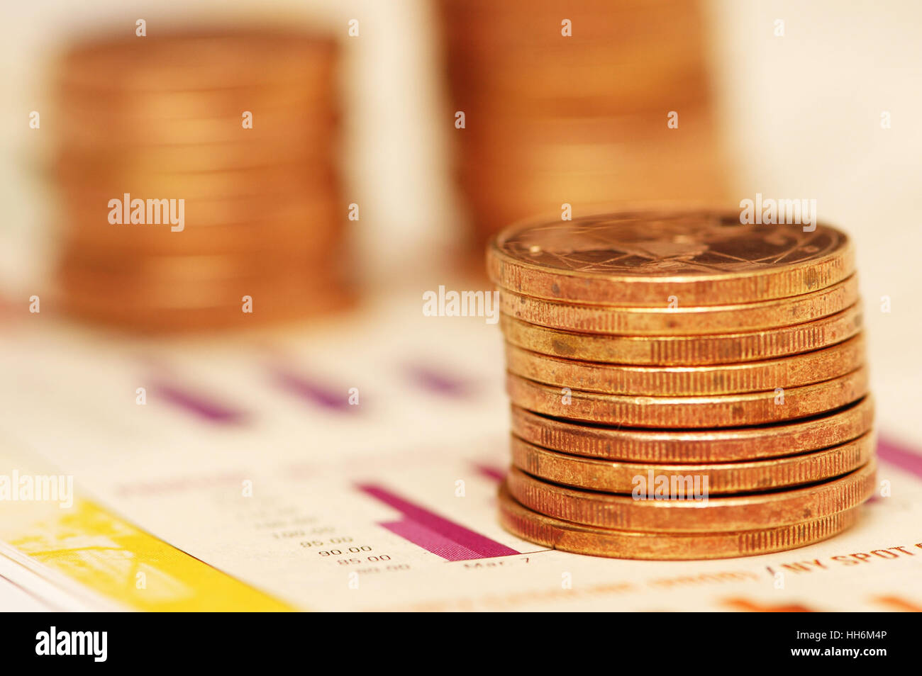 Stack of coins over bar charts with shallow depth of field Stock Photo ...
