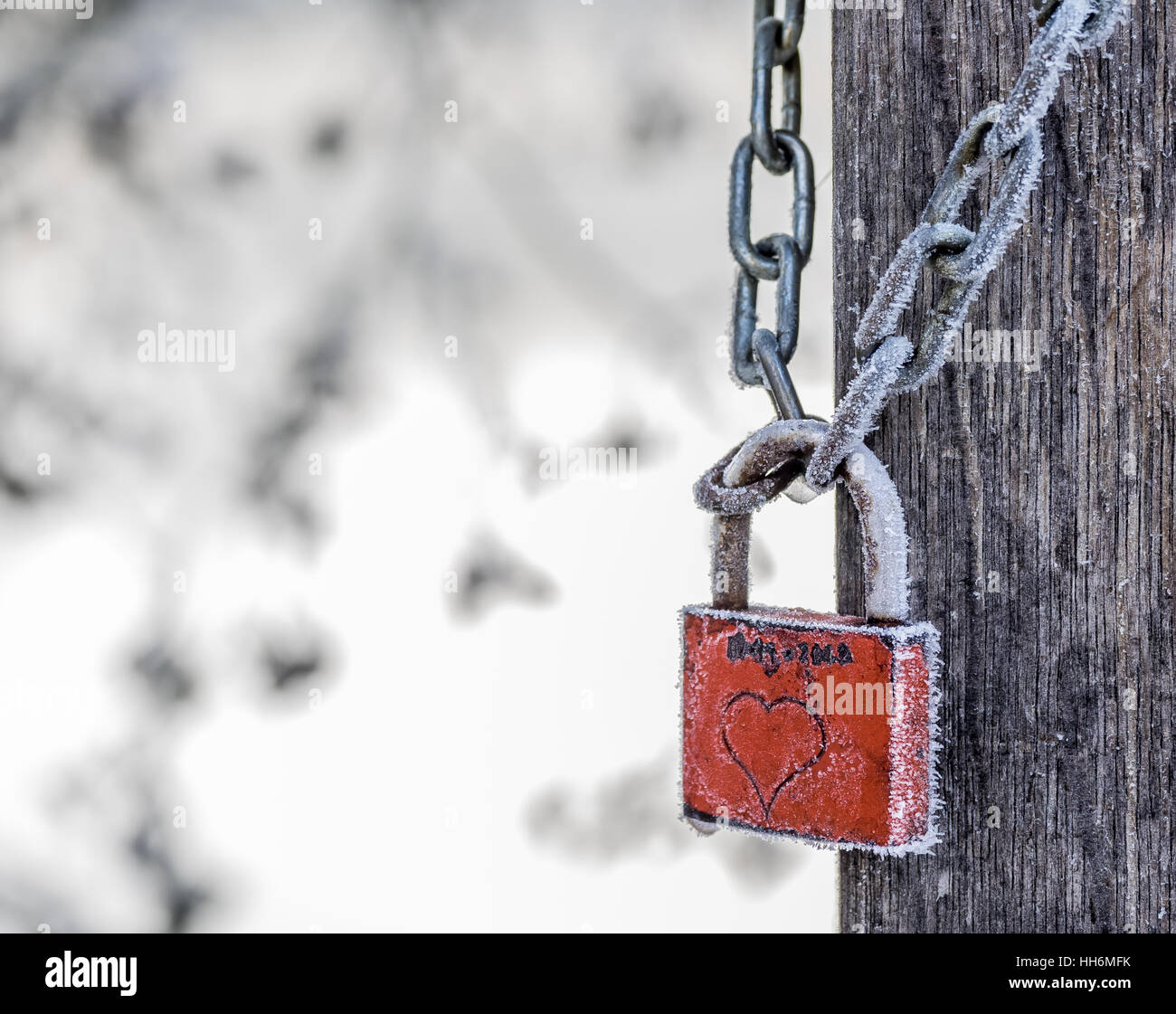 Frost-covered love-lock on a wooden post Stock Photo - Alamy