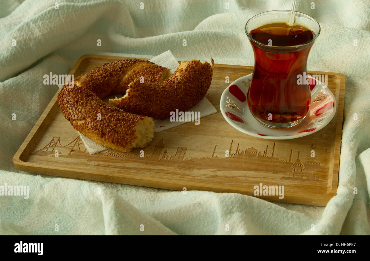 Morning turkish tea in traditional glass with bagel on the tray ...