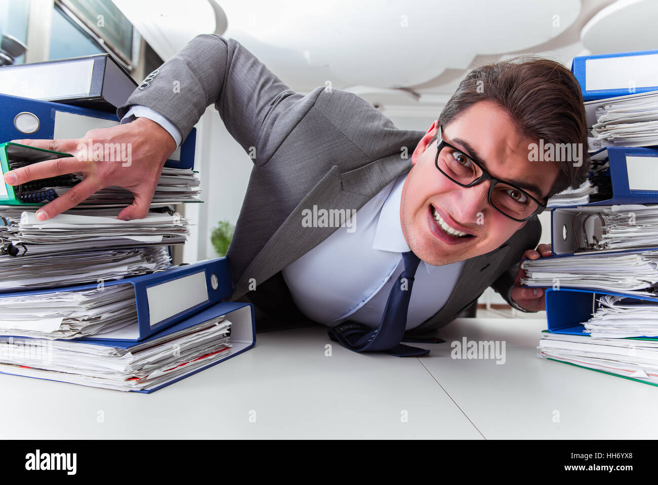 Businessman under stress due to excessive work Stock Photo - Alamy