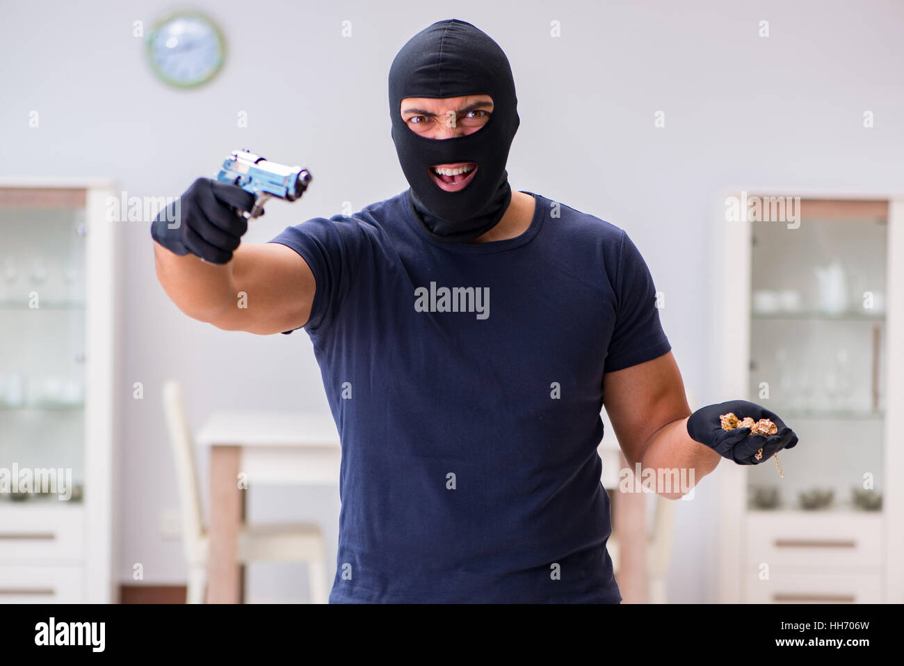 Robber wearing balaclava stealing valuable things Stock Photo - Alamy