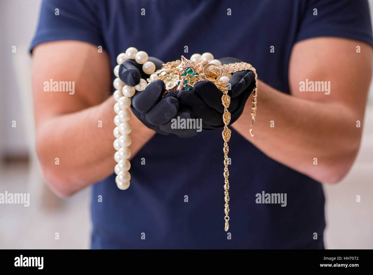 Robber wearing balaclava stealing valuable things Stock Photo - Alamy