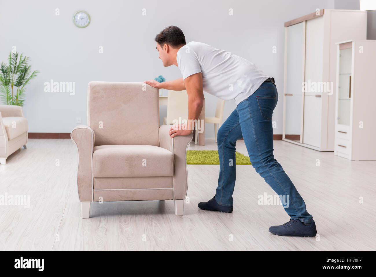 Man moving furniture at home Stock Photo - Alamy