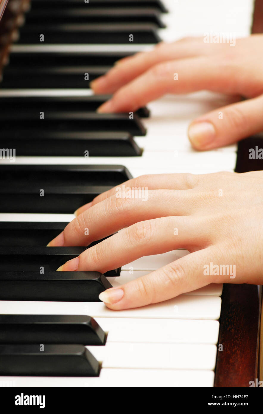 Two hands playing music on the piano Stock Photo - Alamy