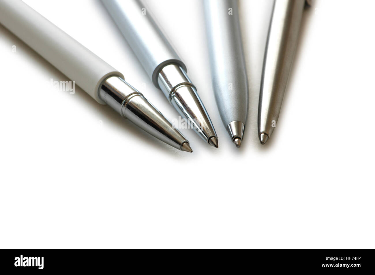 Four pens isolated on the white background Stock Photo - Alamy