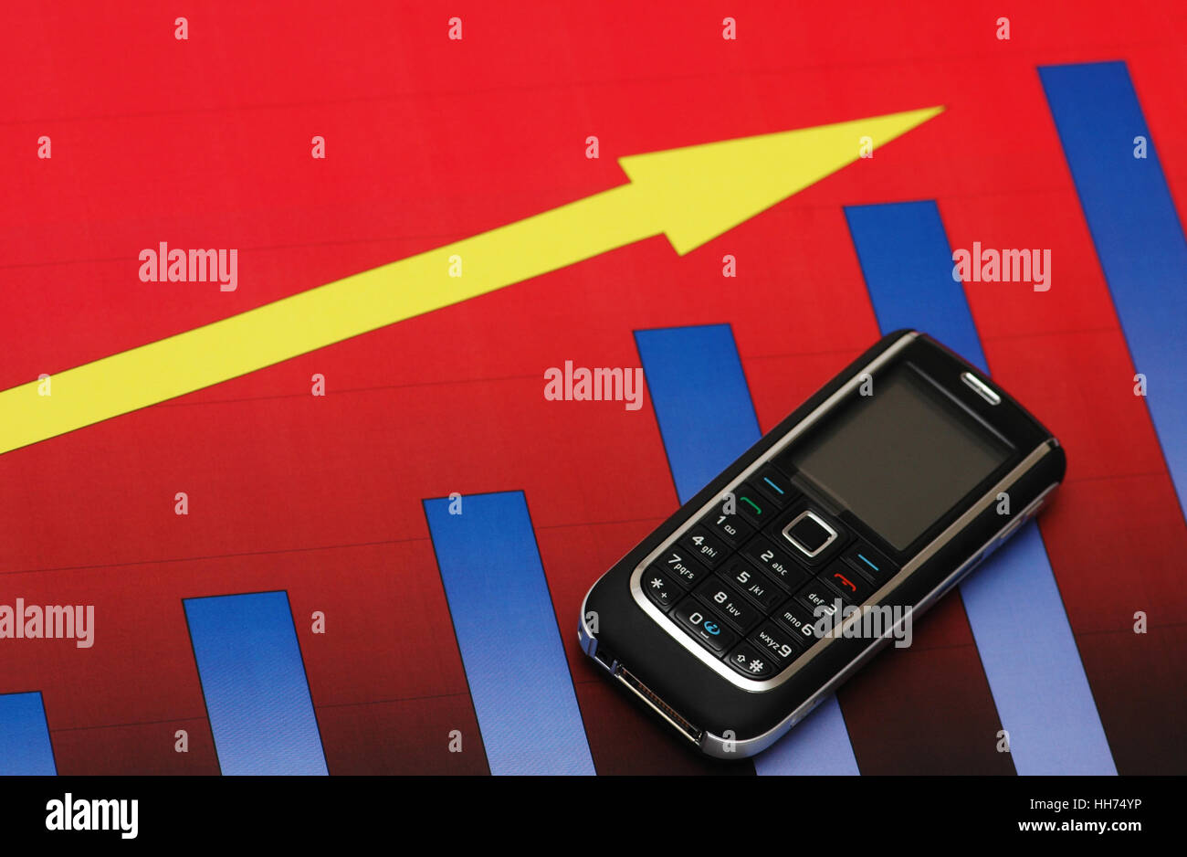 Business concept with mobile phone over the bar chart Stock Photo - Alamy