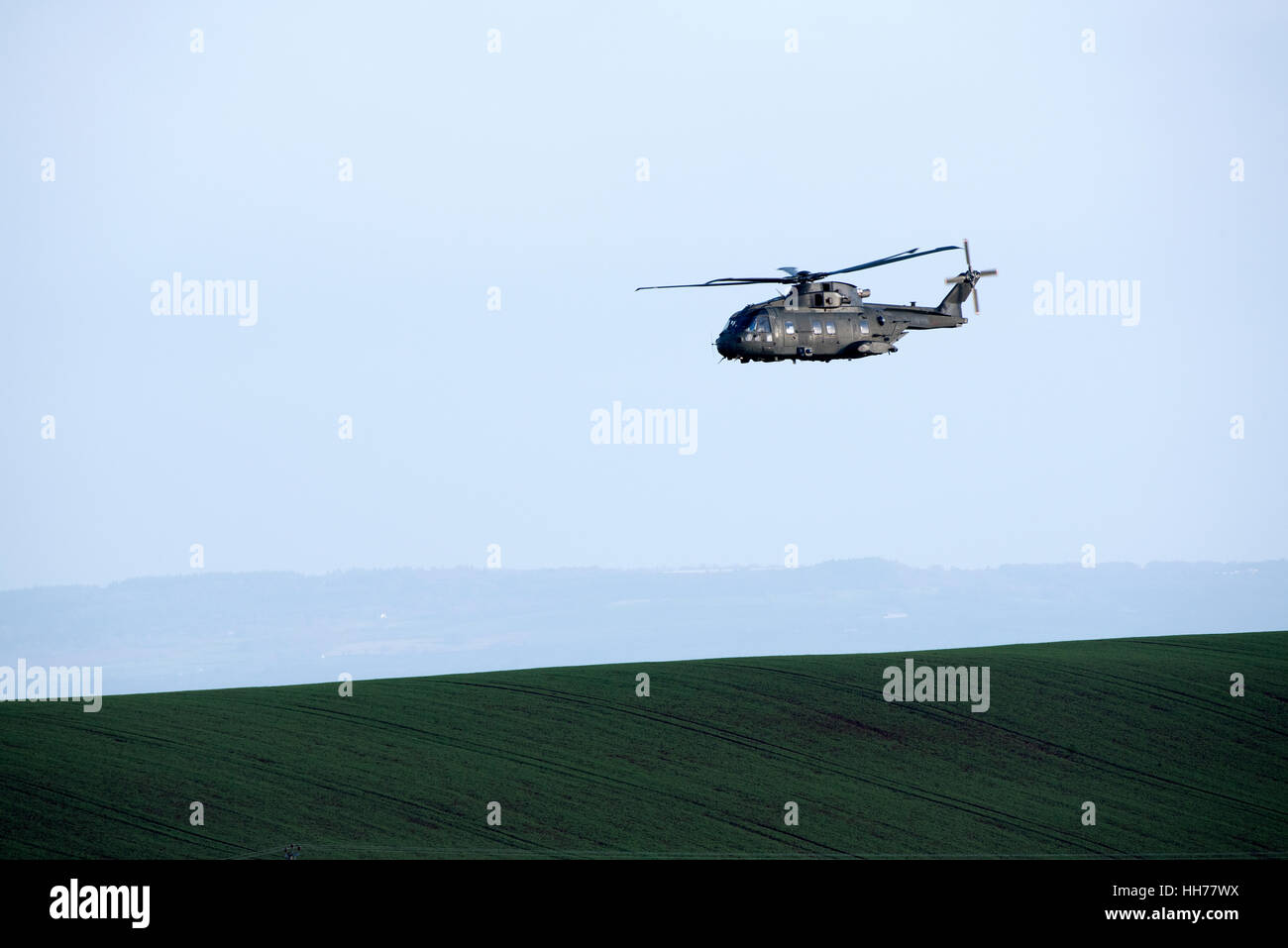 A Merlin MK3 Royal Navy helicopter over farmland in Devon England UK ...