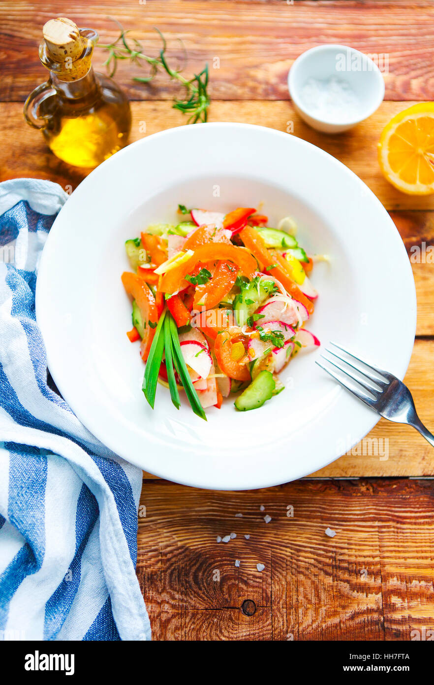 Vegetable spring salad on wooden table Stock Photo - Alamy